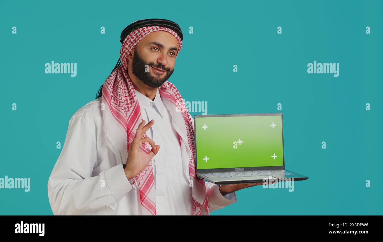 Islamic guy presents greenscreen on pc with smart isolated display for ...