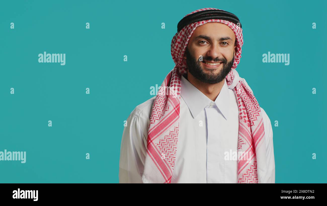 Person wearing national thobe and kufiyah, feeling pleased indicating ...