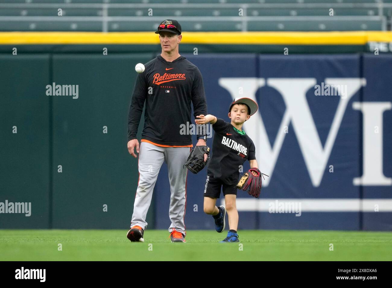 Baltimore Orioles third base coach Tony Mansolino, left, and his six ...