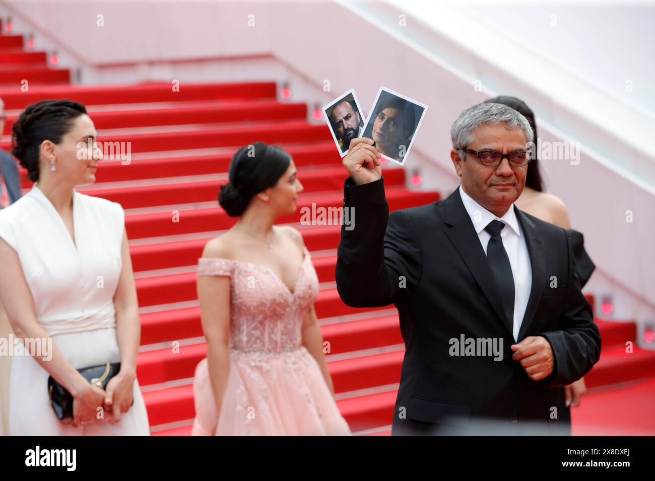 CANNES, FRANCE - MAY 24: Mohammad Rasoulof holds portraits of Iranian ...