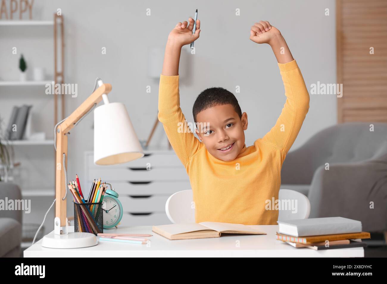 Little African-American boy doing lessons at home Stock Photo - Alamy