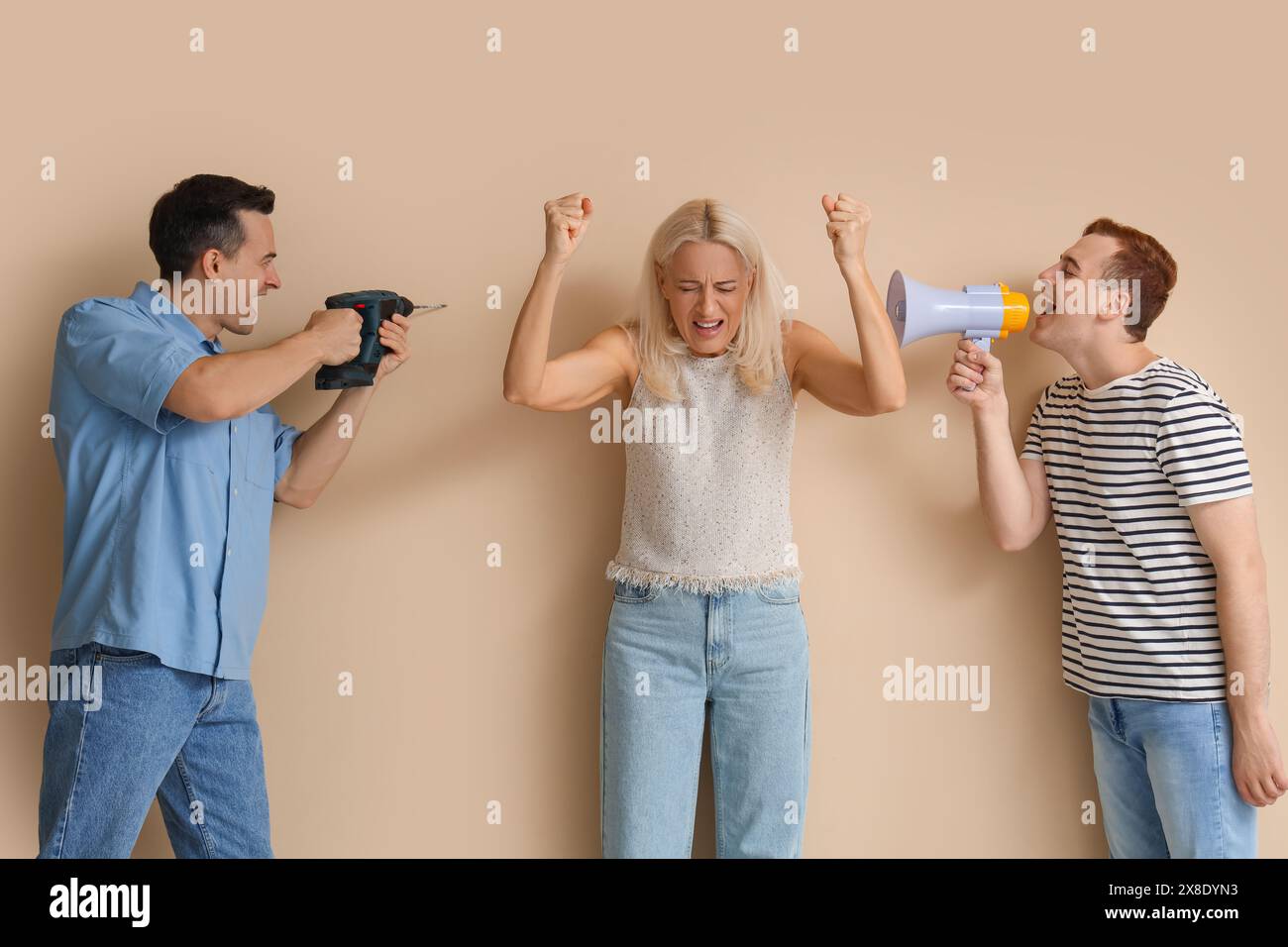 Mature woman suffering from loud neighbours on beige background Stock ...