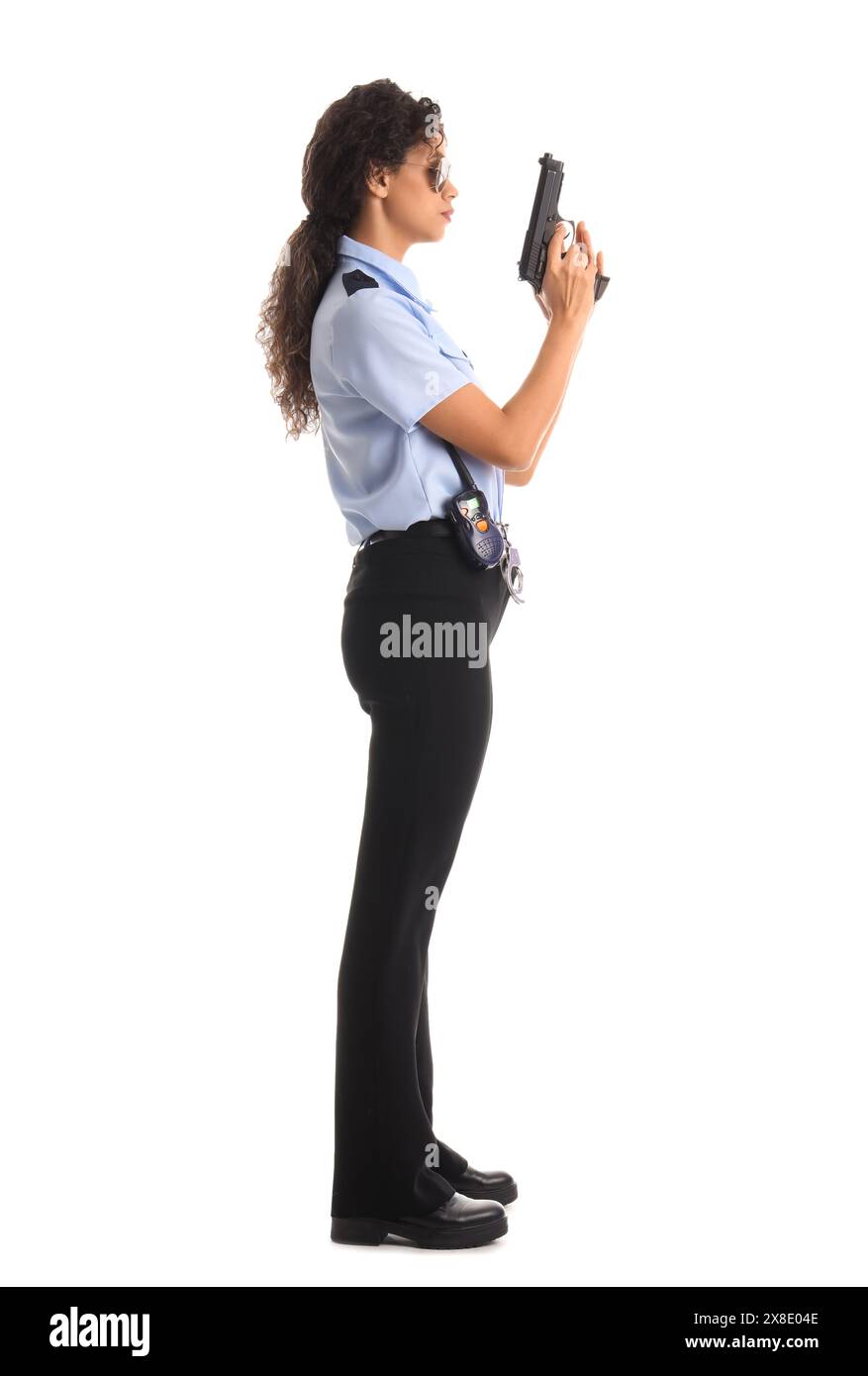 African-American female police officer with gun on white background ...