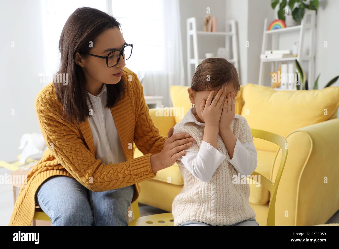 Female psychologist working with crying little girl in office Stock ...
