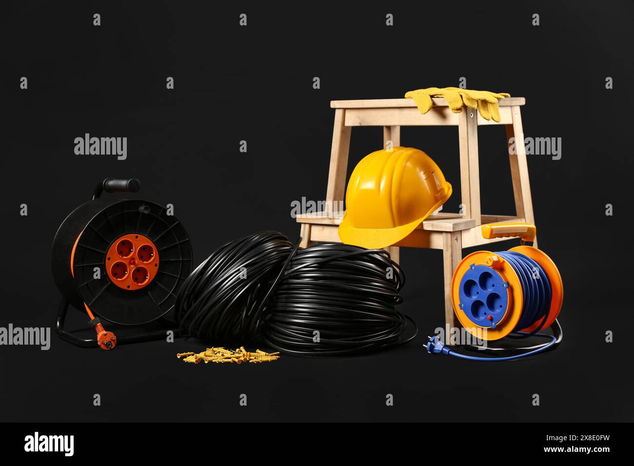 Stepladder with hardhat, rolled wires, extension cable reels and wall ...