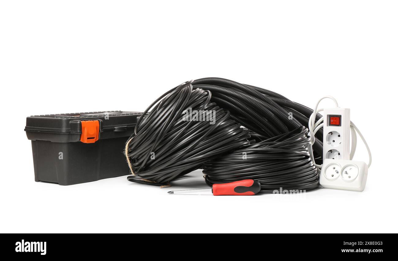Rolled cables, flexible conduit tube, tool box and extension cord on ...