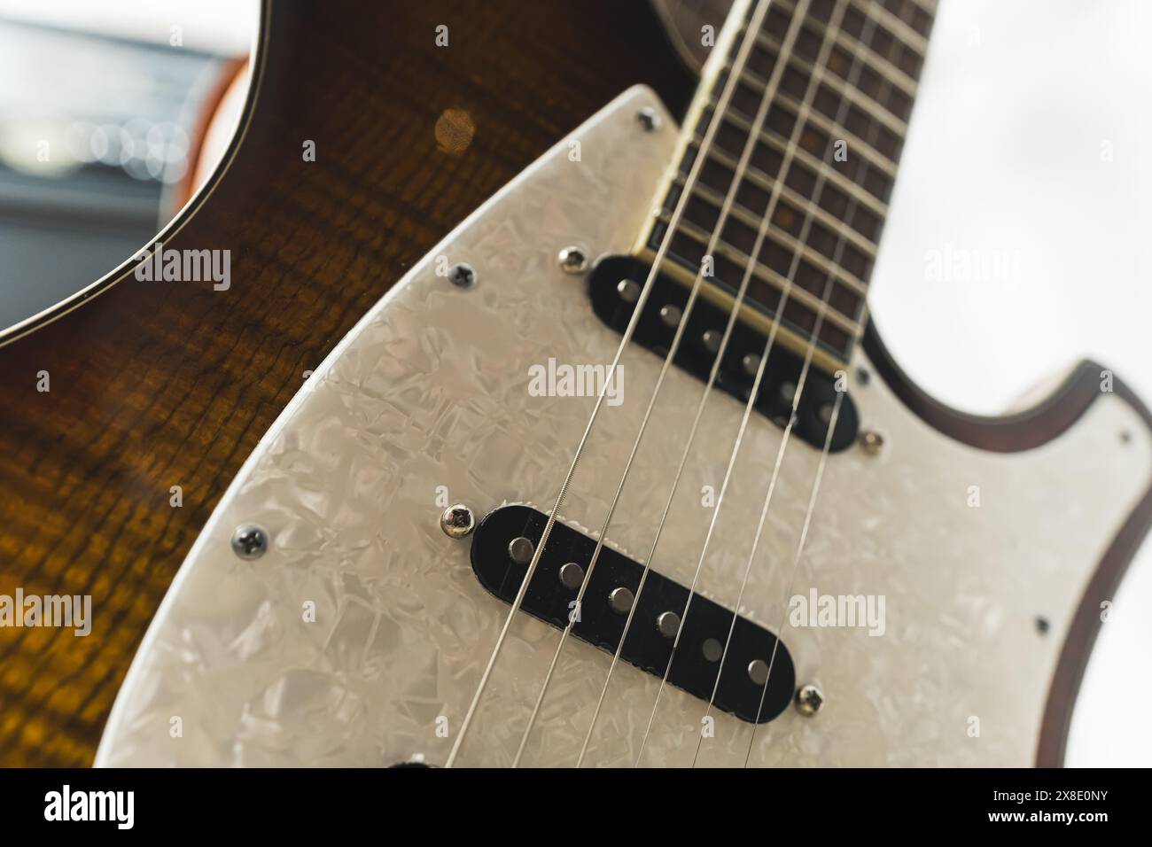 closeup shot of a modern guitar with white stripes, musical instrument ...