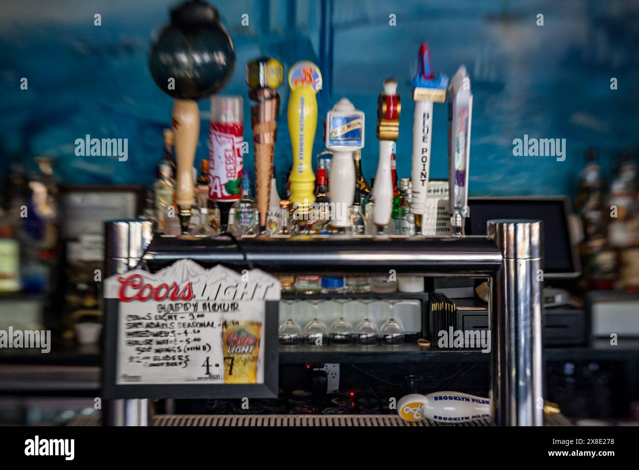 A draft beer system with 8 tap handles of different american brands ...