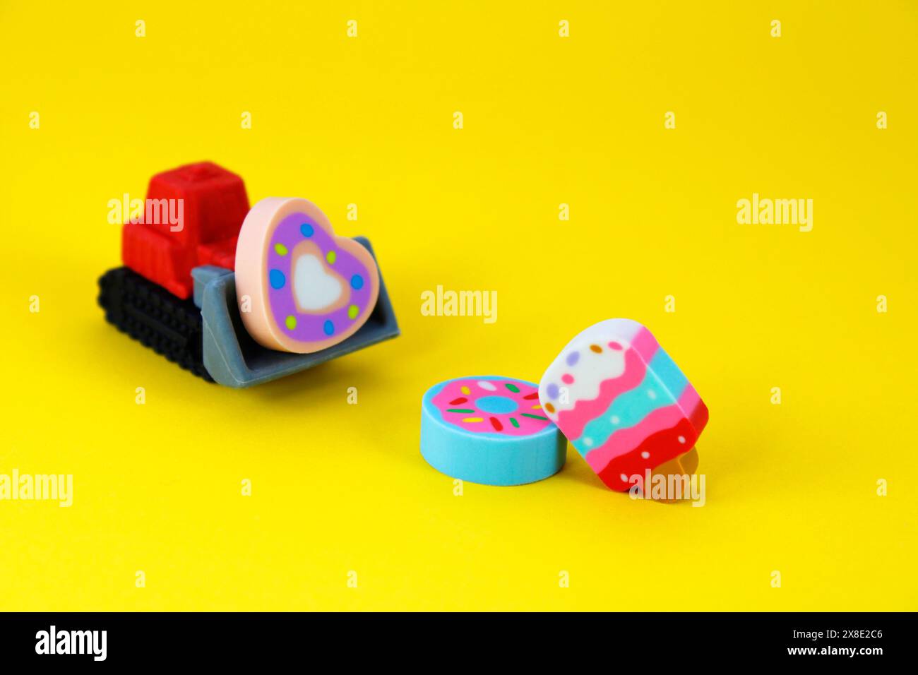Erasers, backhoe loading colorful heart Stock Photo - Alamy