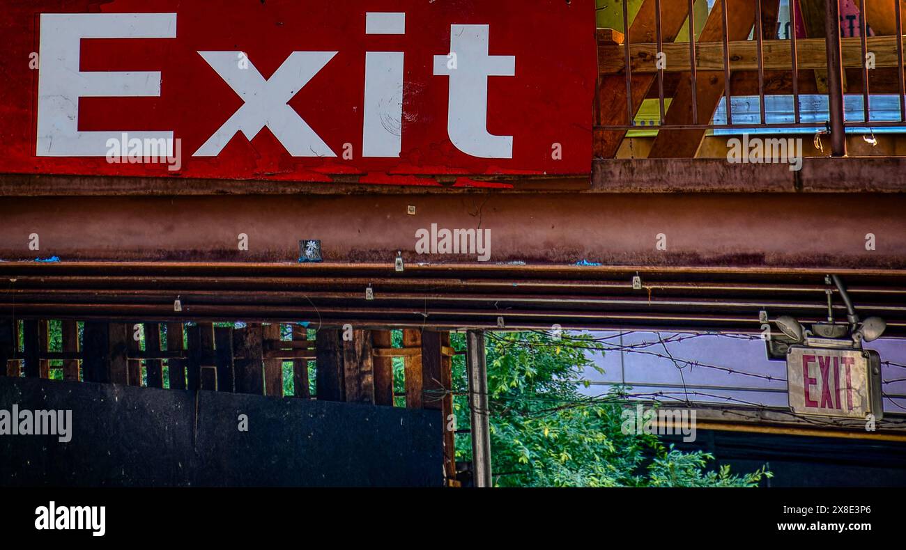 Two exit signs in an outdoor restarant Stock Photo - Alamy