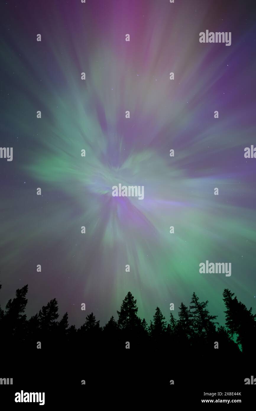 Aurora Borealis rays converging at auroral corona point in night sky in ...