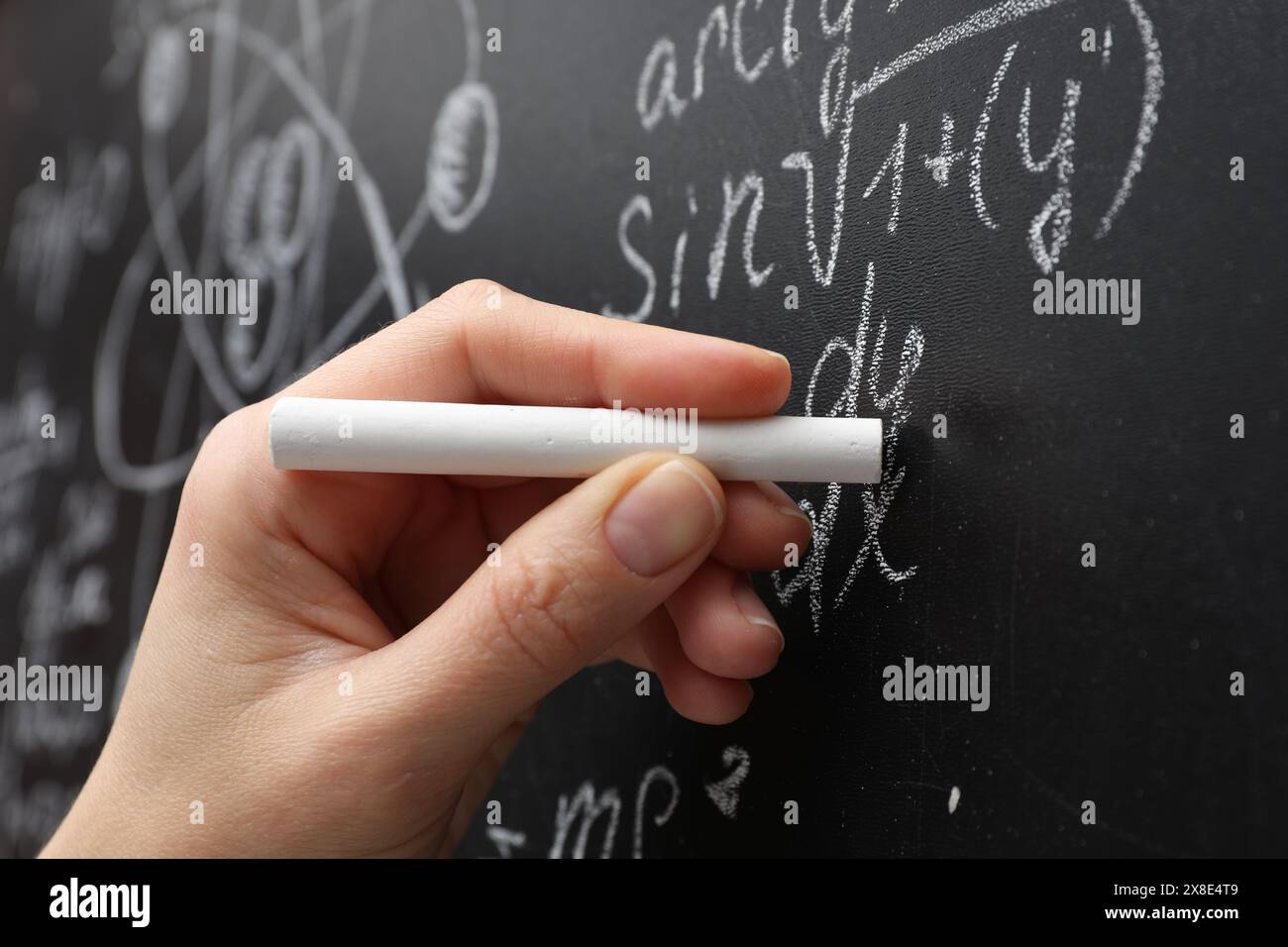 Teacher writing math formulas with chalk on blackboard, closeup Stock ...