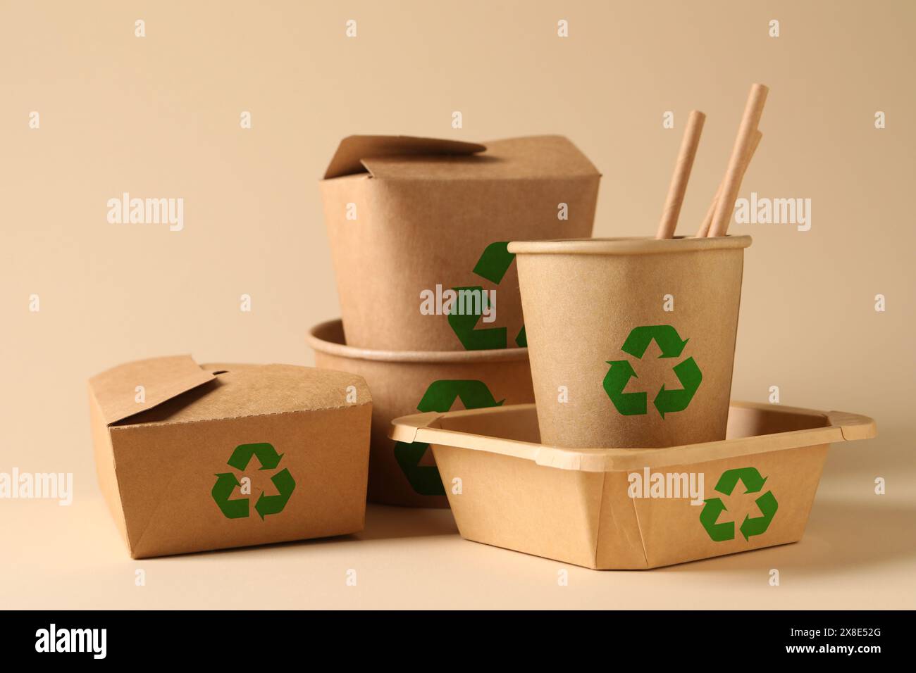 Set of eco friendly food packaging with recycling symbols on beige ...