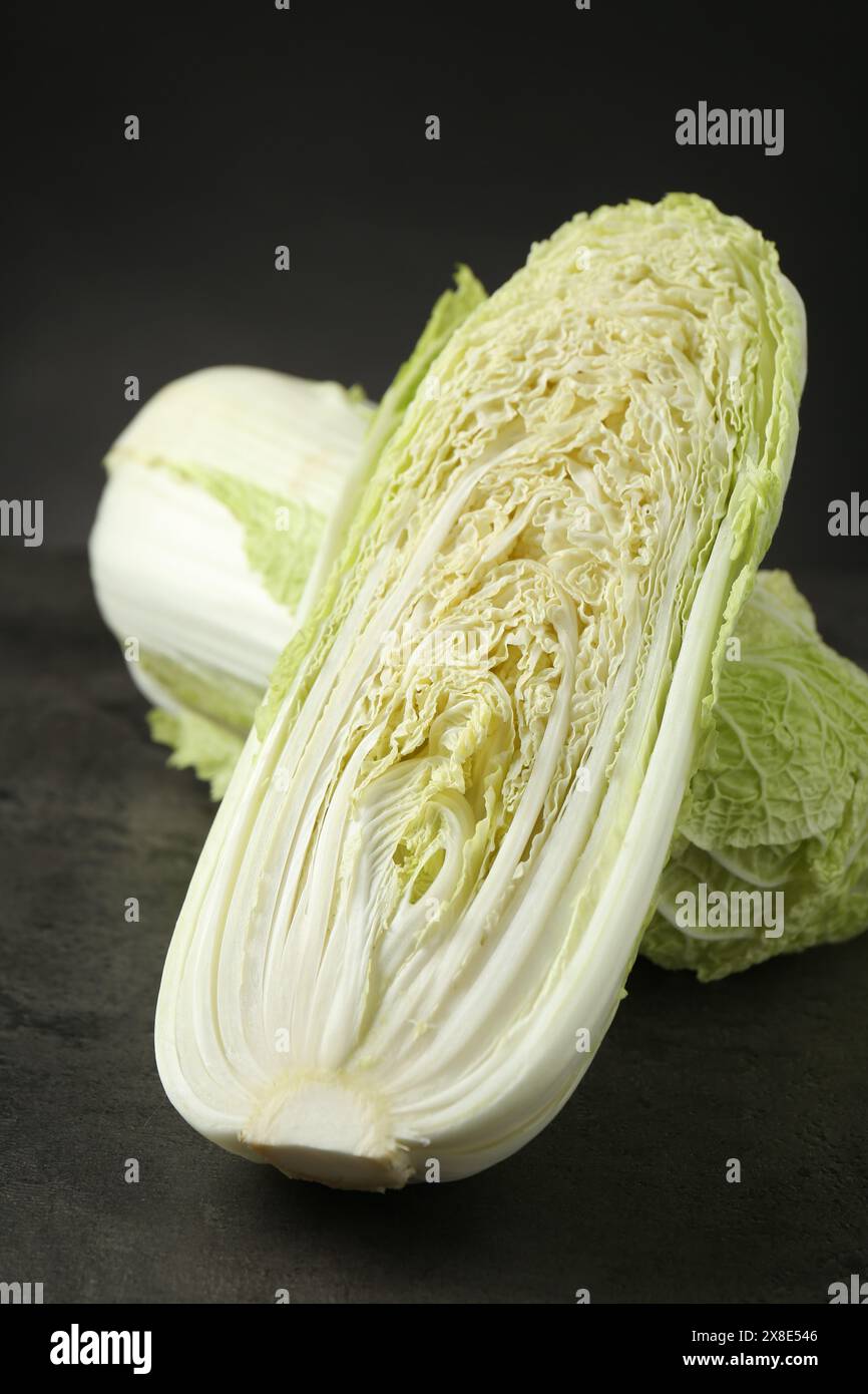 Whole and cut fresh Chinese cabbages on grey table Stock Photo - Alamy