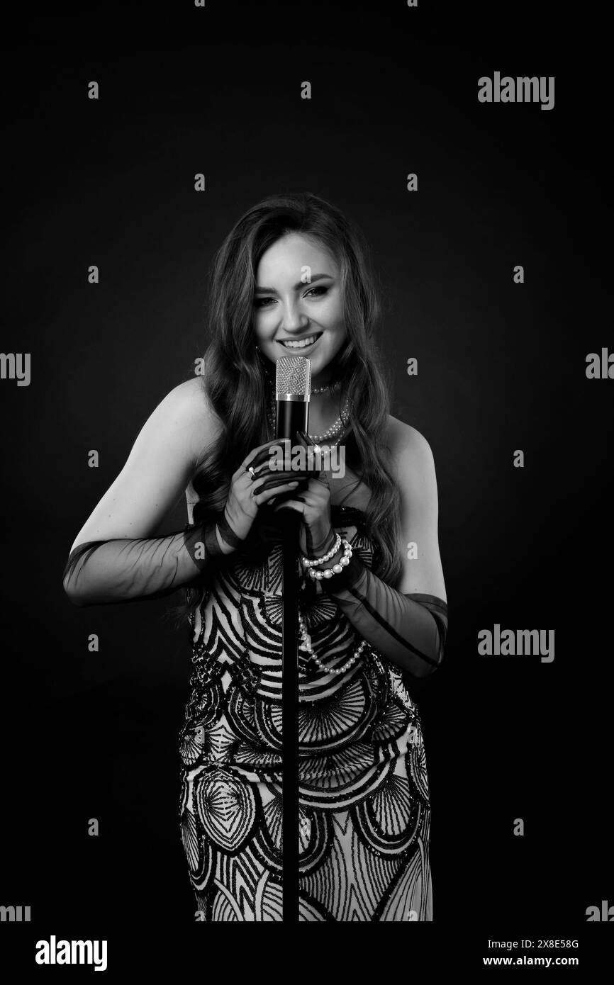 Beautiful singer with microphone, black and white effect Stock Photo ...