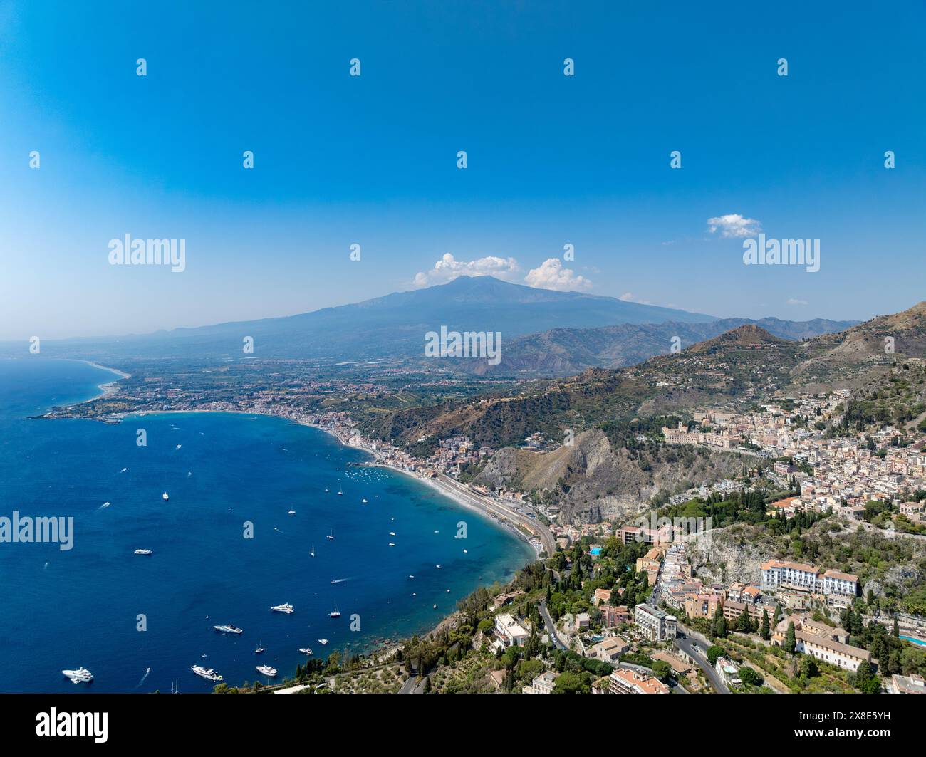 Aerial view of the beach of Taormina in the blue waters of the Ionian ...