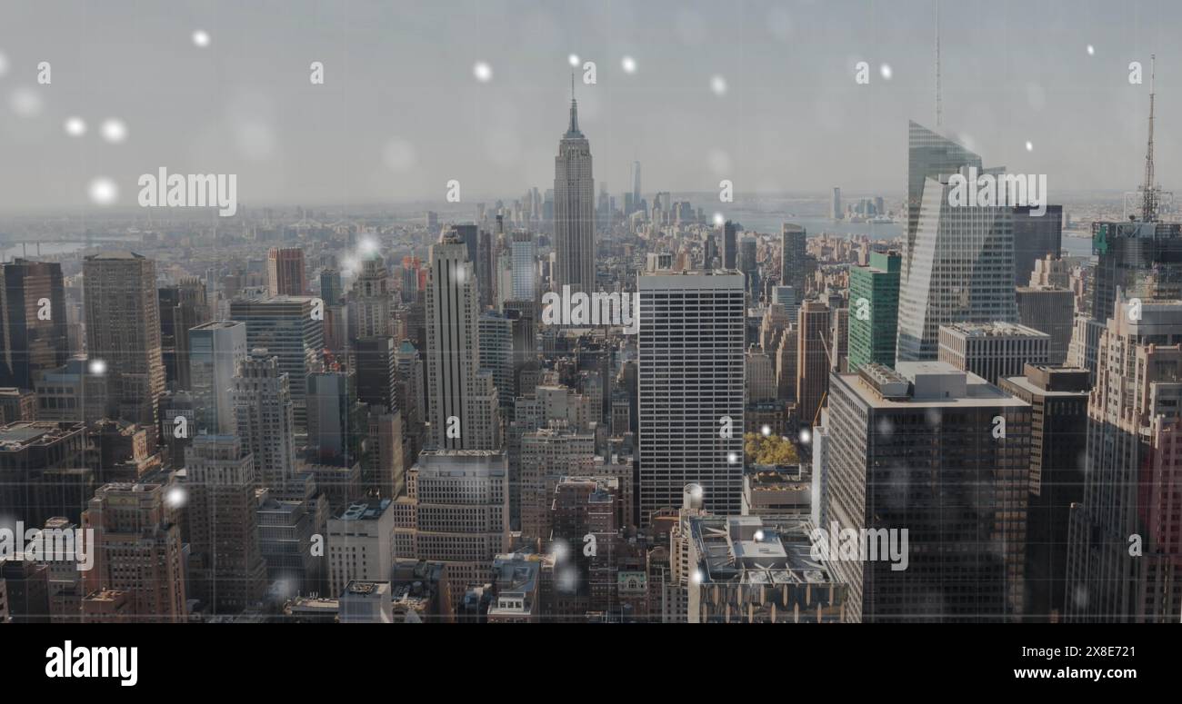 Snowflakes gently falling over bustling city skyline Stock Photo - Alamy