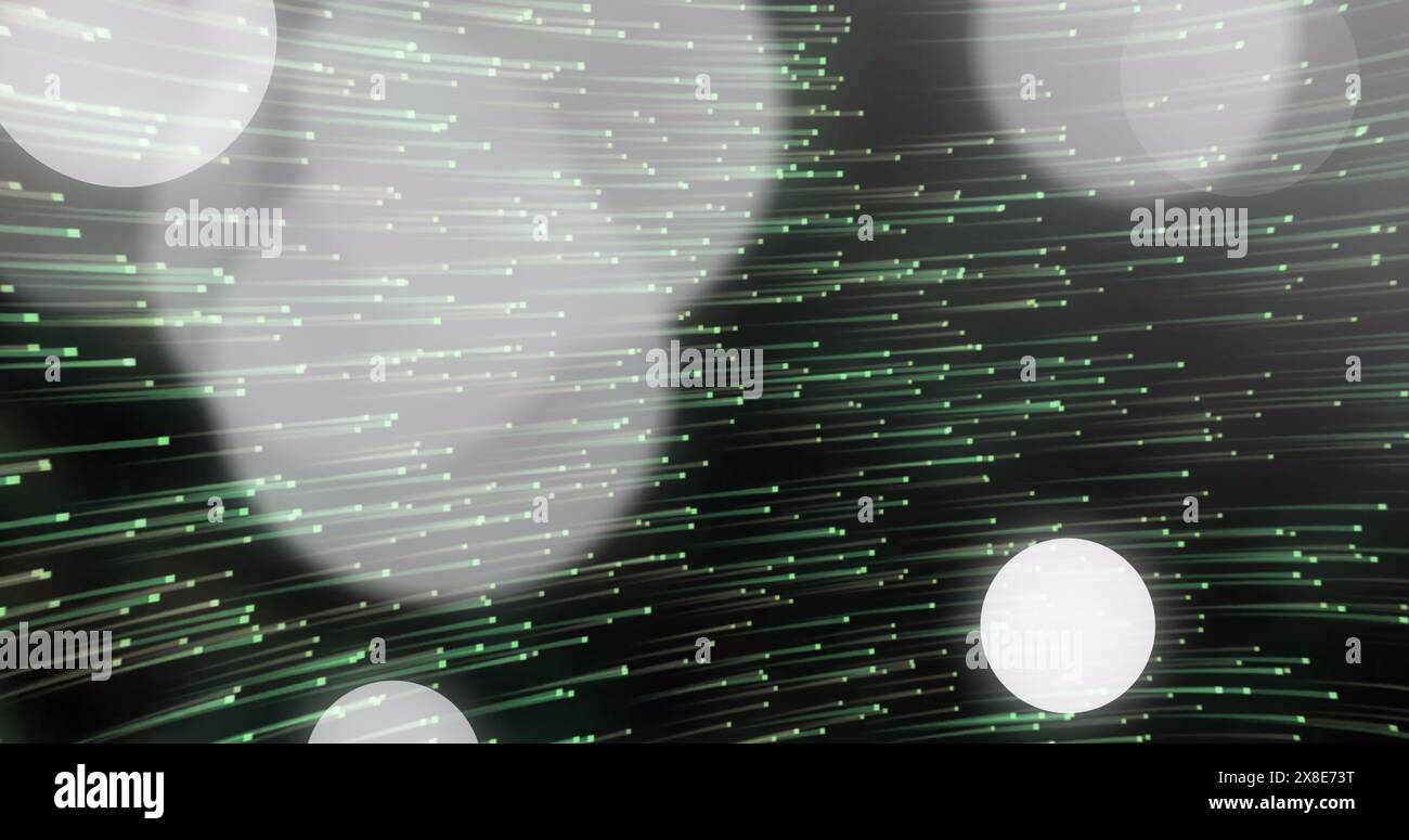 Image of spots of light over green light trails Stock Photo - Alamy