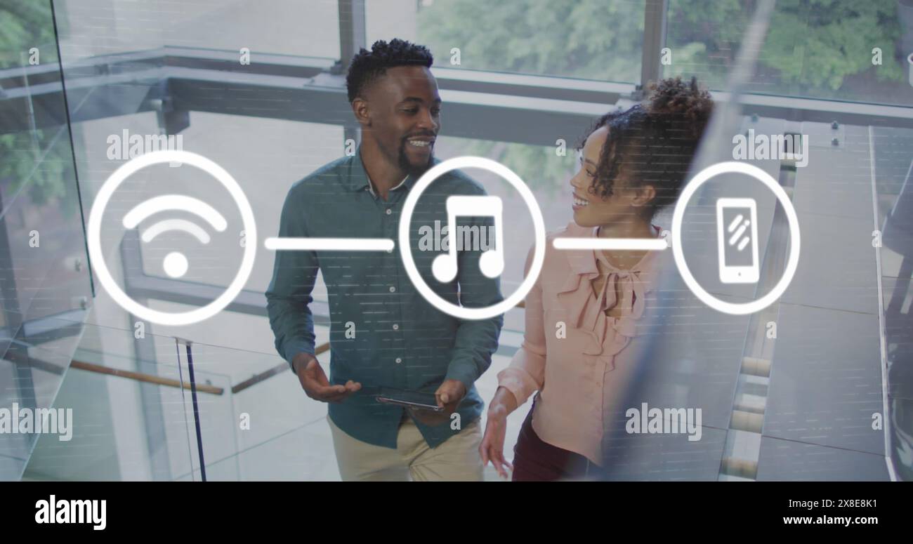 Image of icons connected with lines over diverse coworkers talking while climbing staircase ...