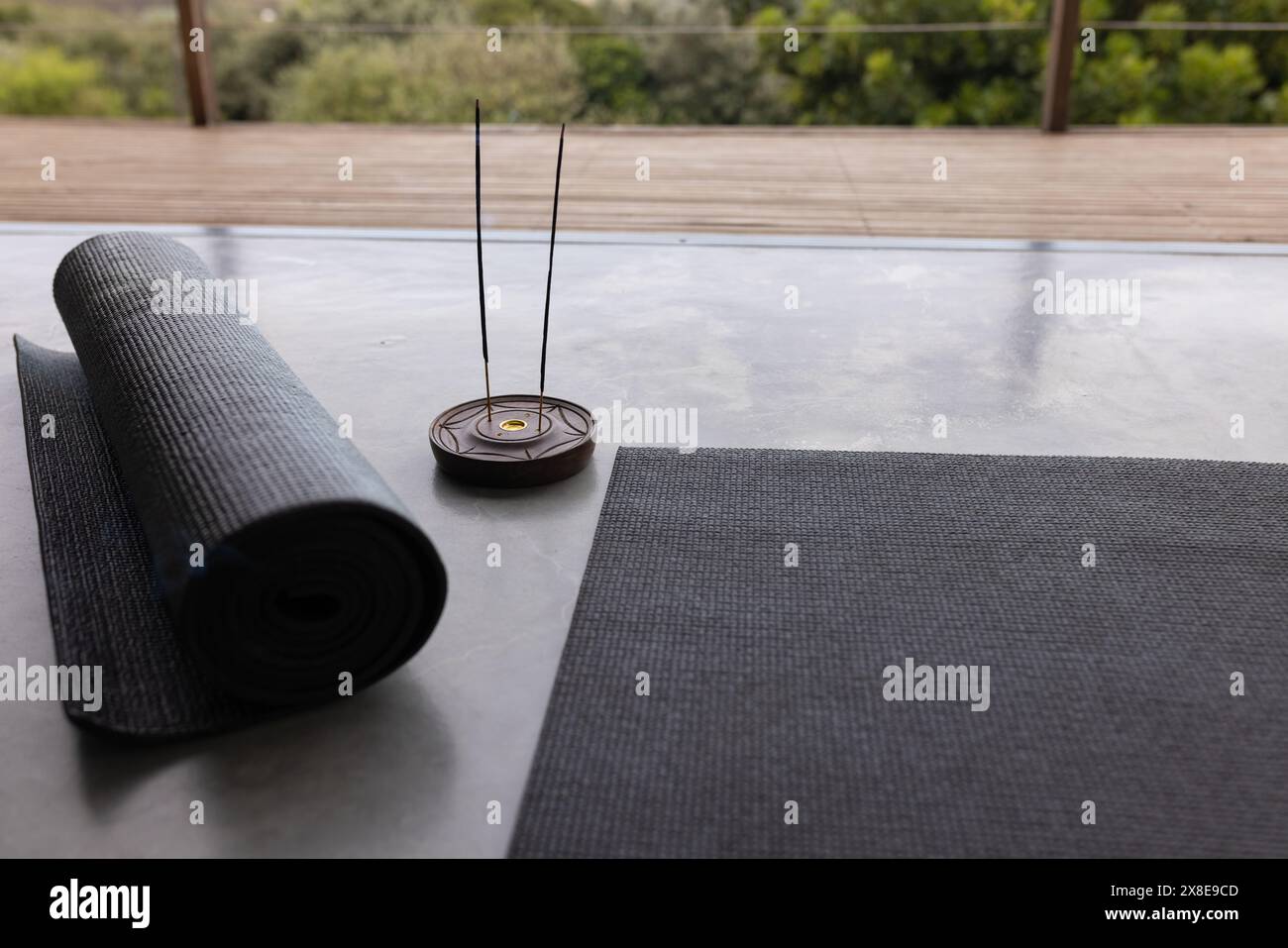 At home, yoga mat and incense burner resting on a sleek surface Stock ...
