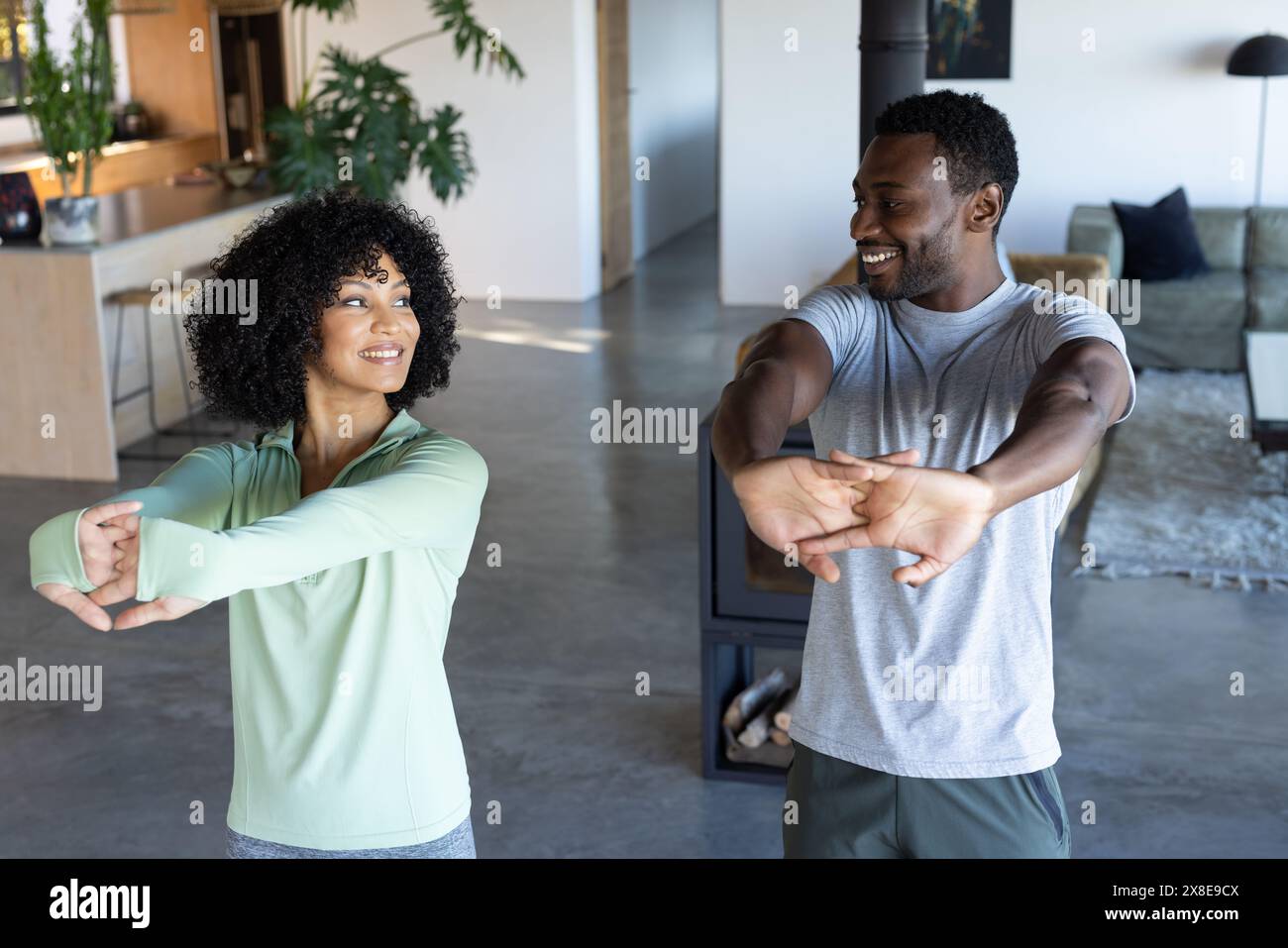 A diverse couple dancing at home in casual clothes Stock Photo - Alamy