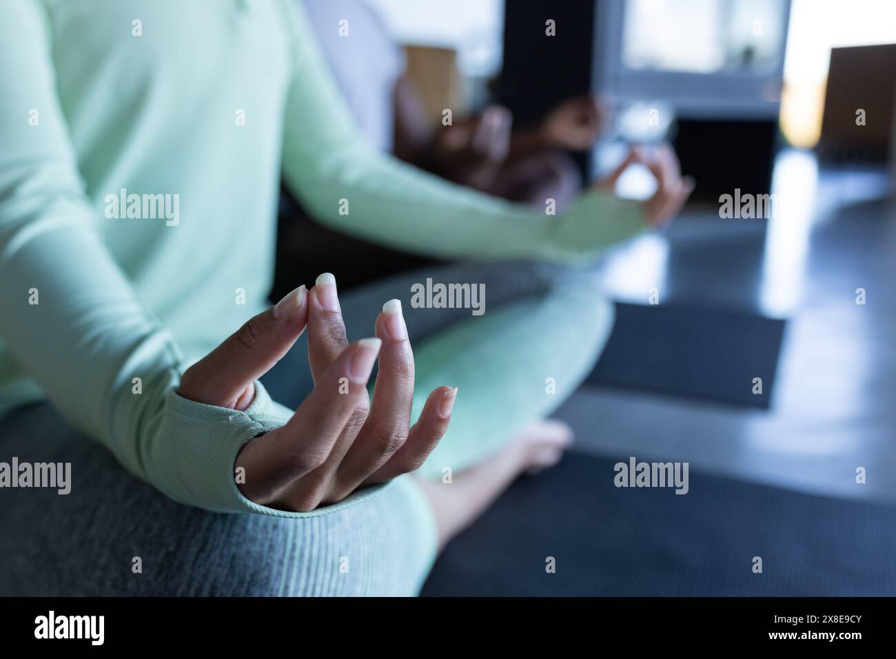 A diverse couple at home, meditating together in peace Stock Photo - Alamy