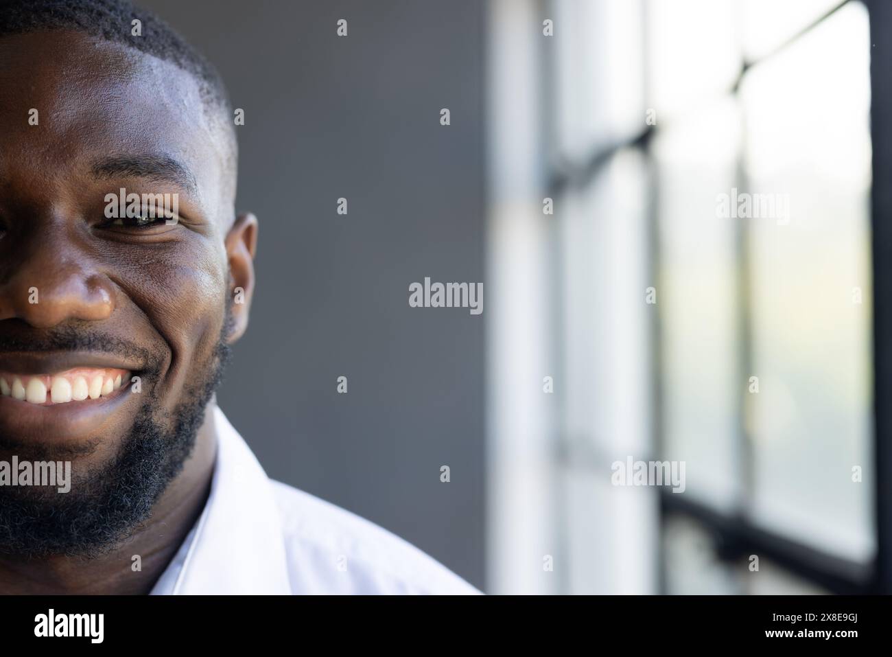 Young African American male with short black hair and beard smiling ...
