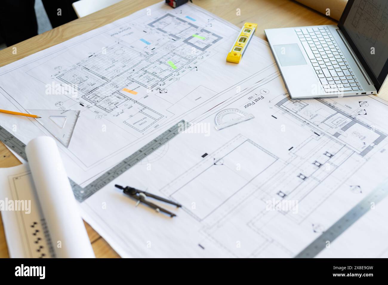 Architectural blueprints and drafting tools are on wooden table Stock ...