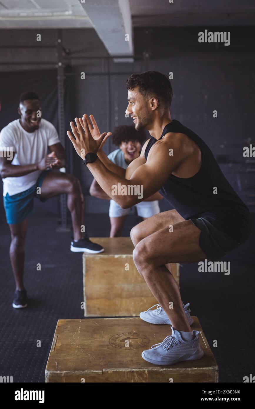 A group of diverse men at gym working out together, performing box ...