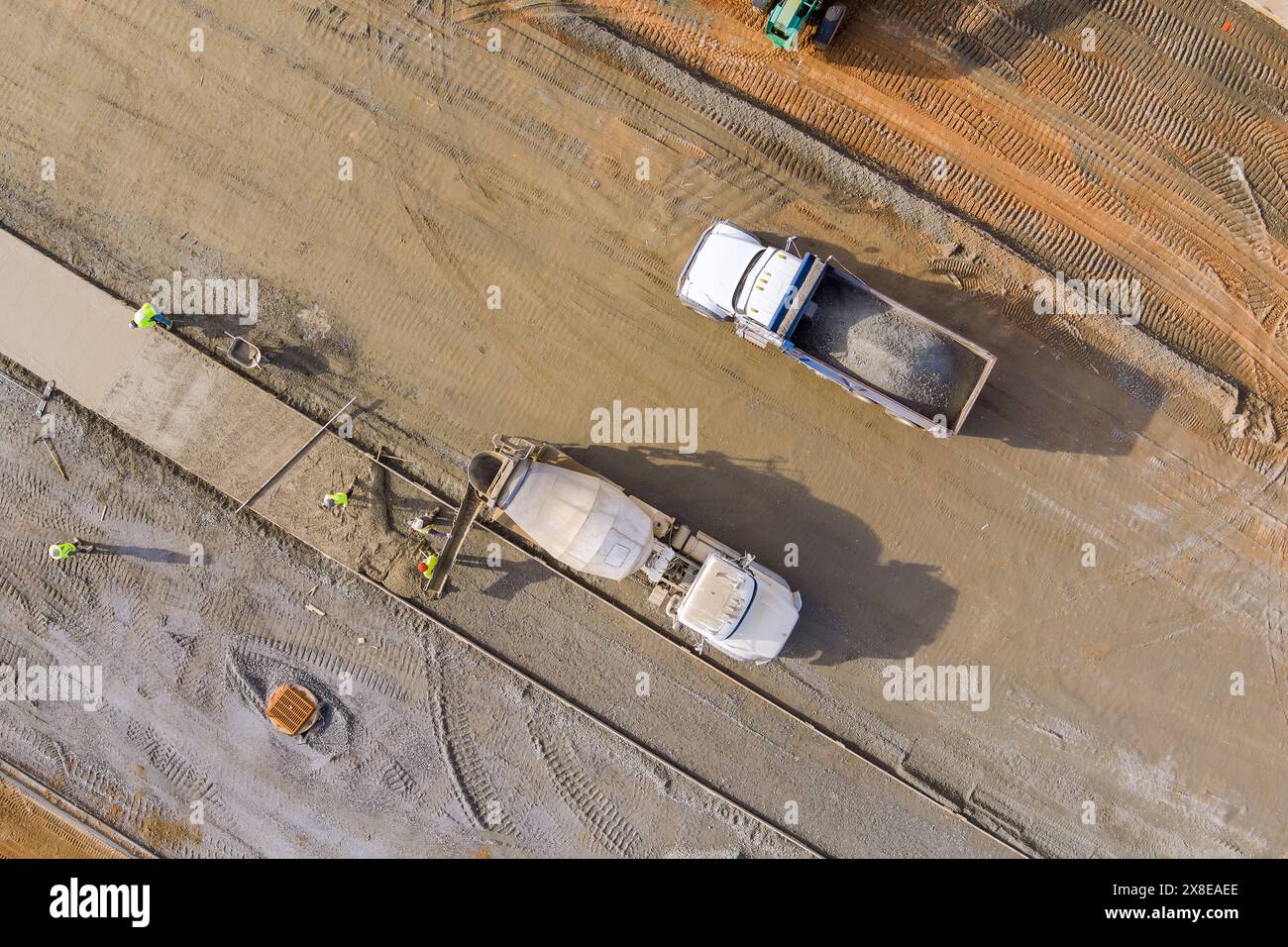Mason workers intro pouring concrete from mixer machines truck for ...