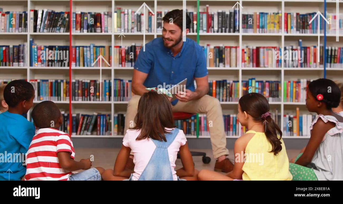 Caucasian male brother reading to diverse group of children in school ...