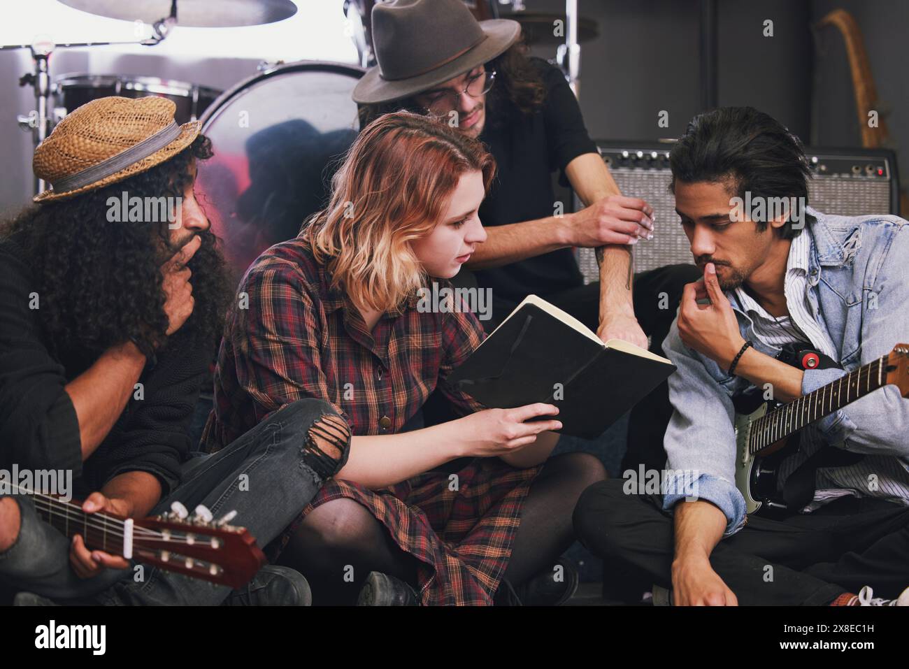 Band, people and notebook for lyrics in music studio with brainstorming ...