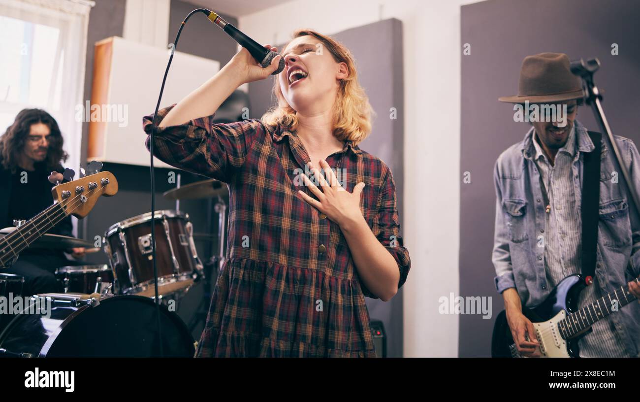 People, band and music practice with singer, microphone and electric ...