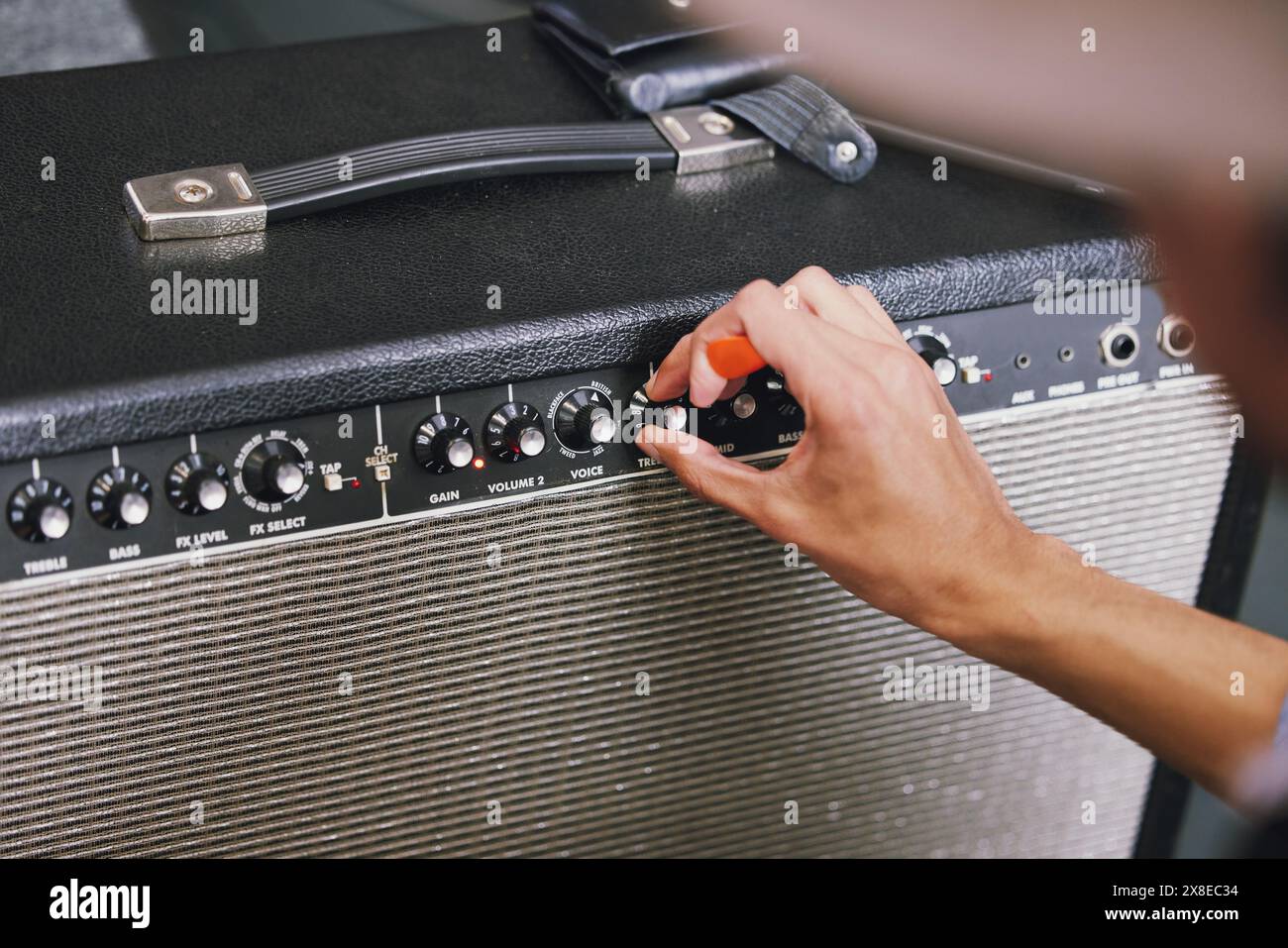Hand, dial and amplifier for volume in music studio for process, mixing ...