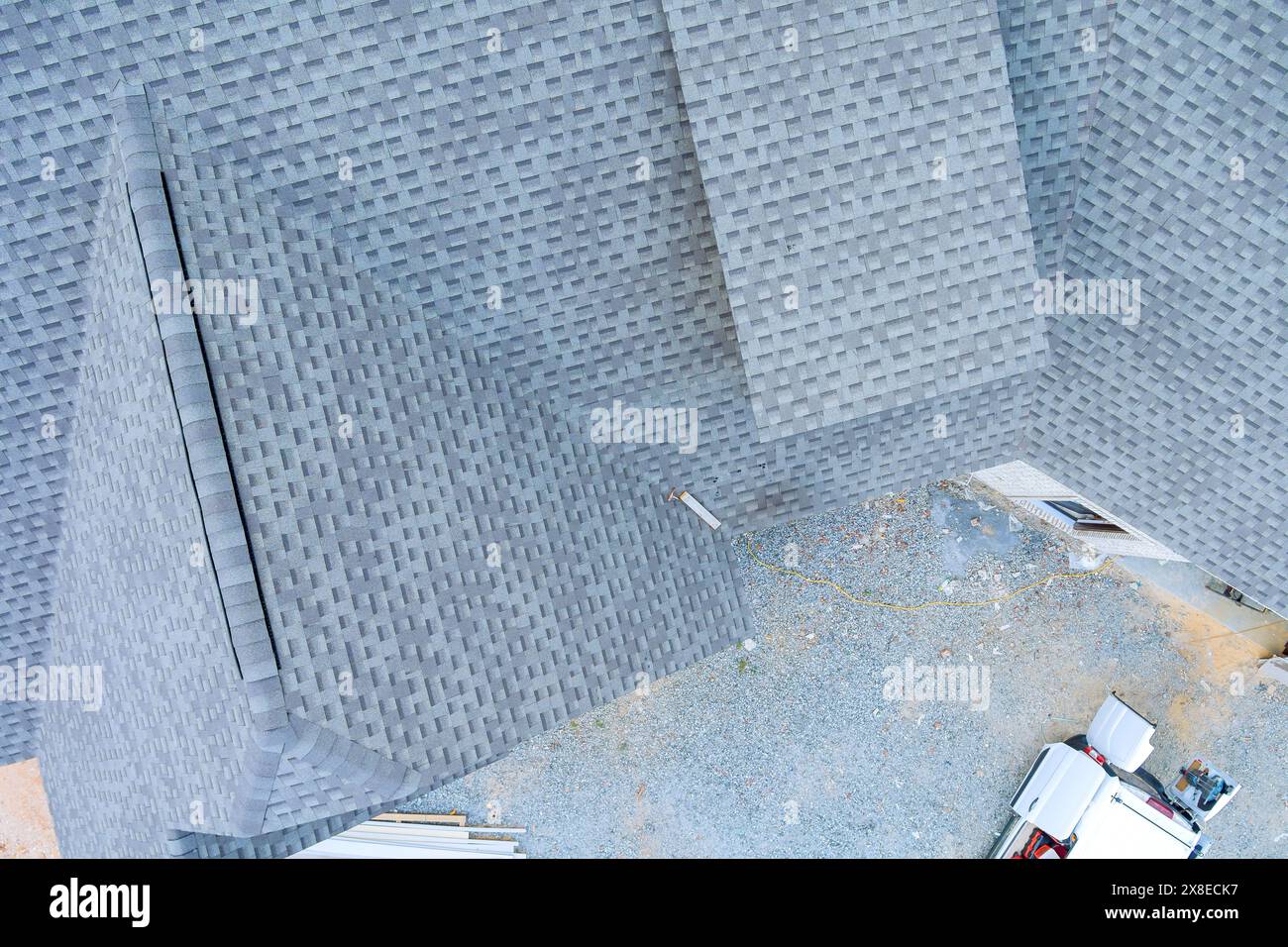 While construction is in progress, roof of new house is being covered ...