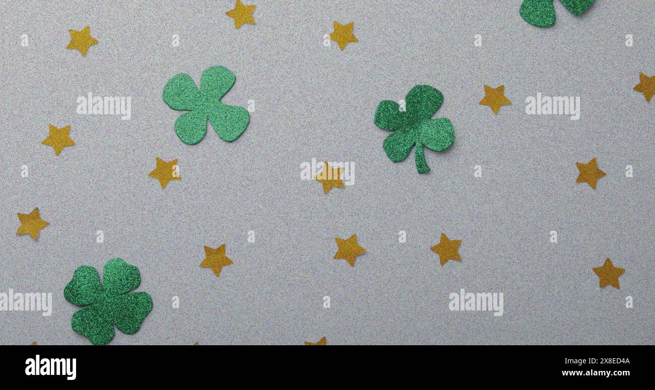 Green clover cutouts and yellow stars decorating grey background Stock ...