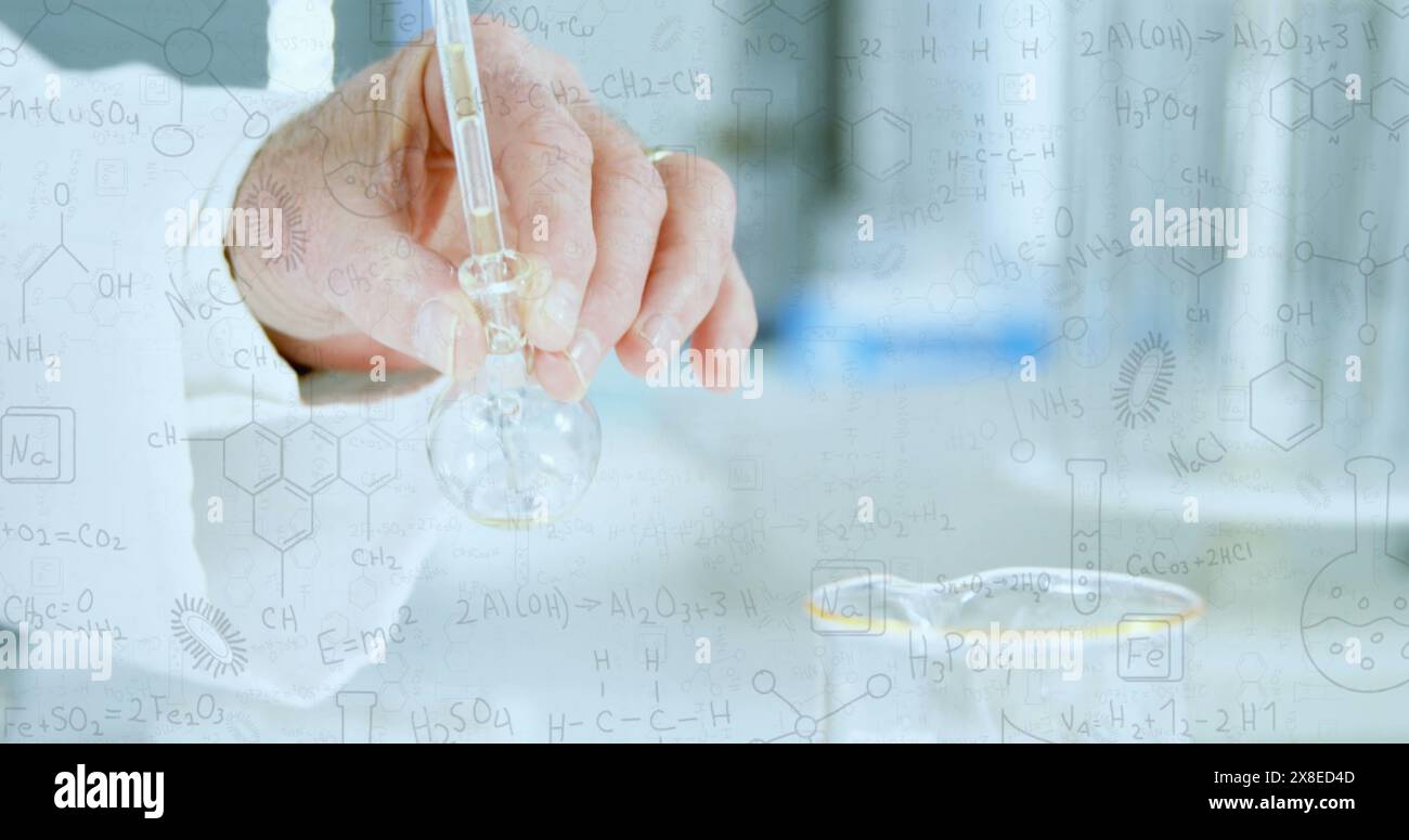 Caucasian senior male scientist holding flask, examining a clear liquid ...