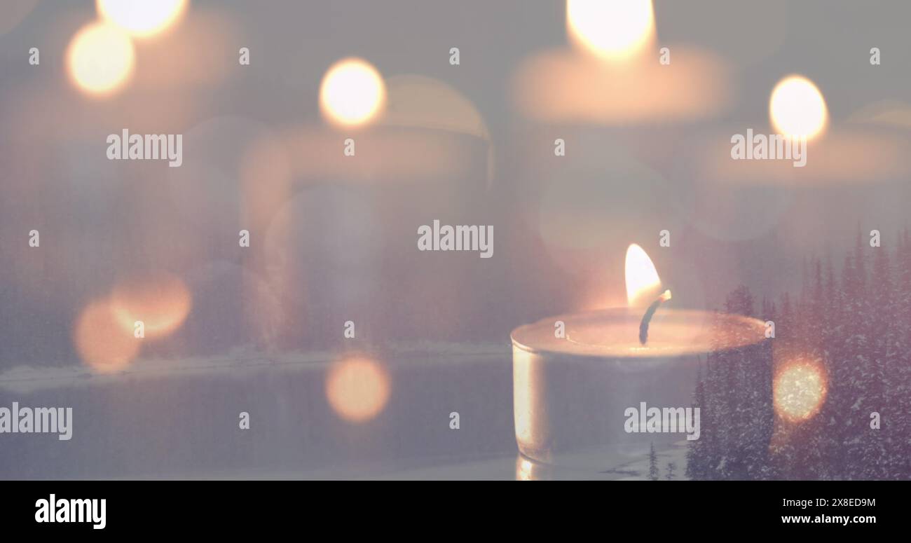 Candle burning, casting soft lights against snowy landscape Stock Photo ...