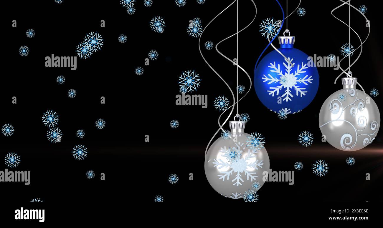 Image of snow flakes falling over hanging bauble decorations and light ...