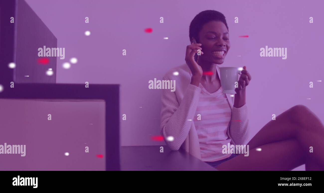 Image of red and white spots over happy african american woman talking ...