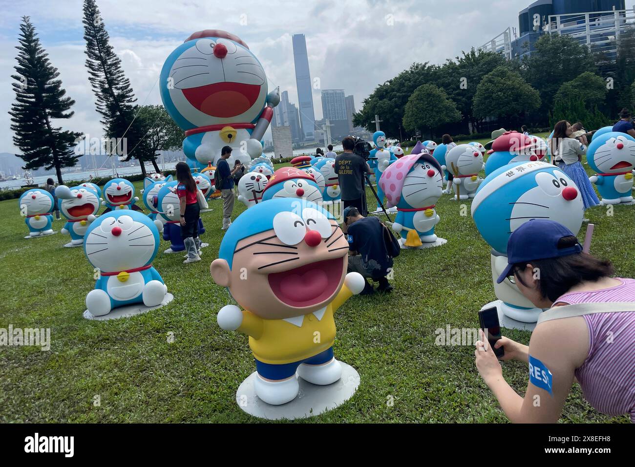 Media pose with models of popular Japanese cartoon character Doraemon ...