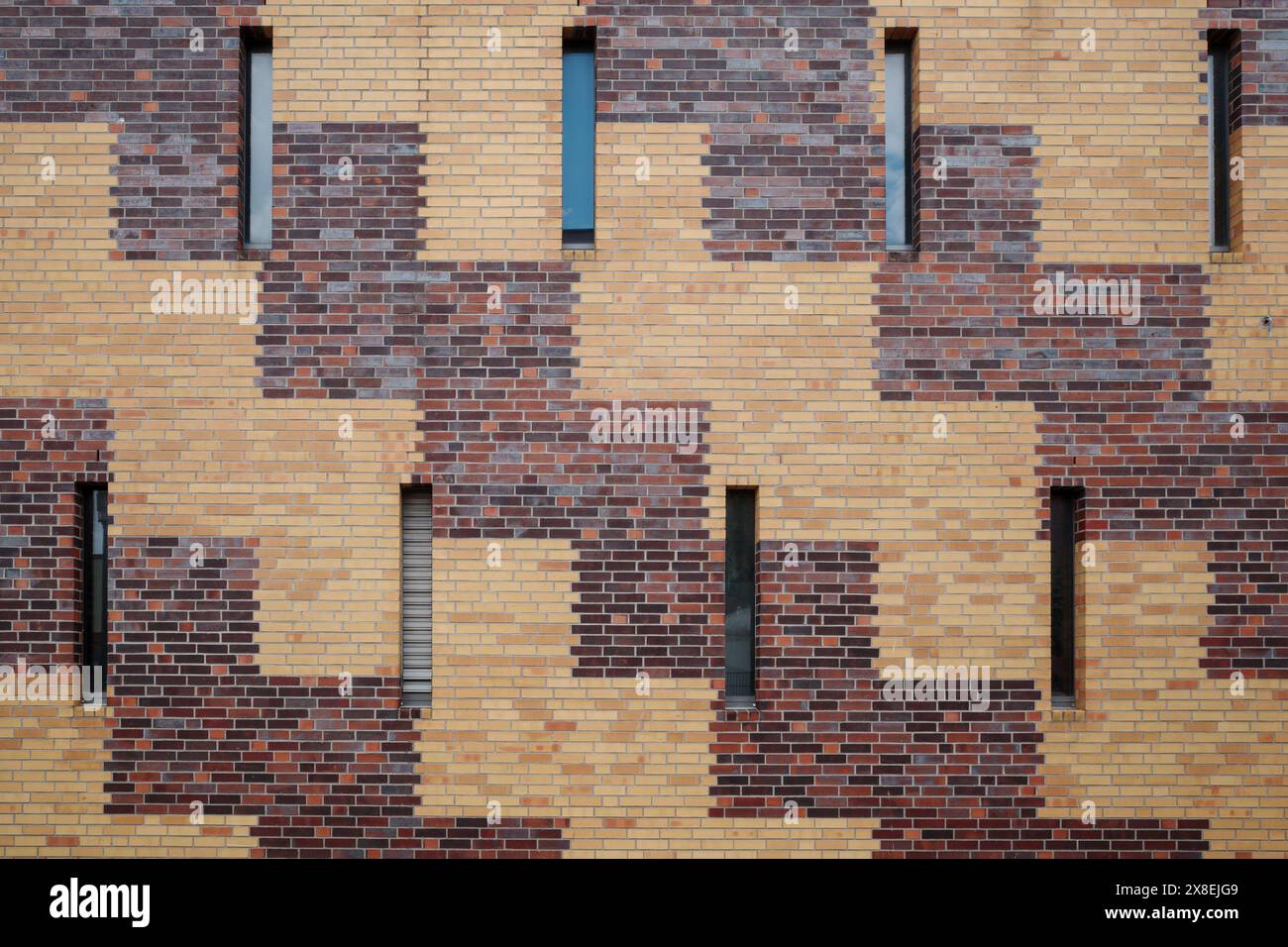 A modern brick wall with an intricate geometric pattern formed by ...