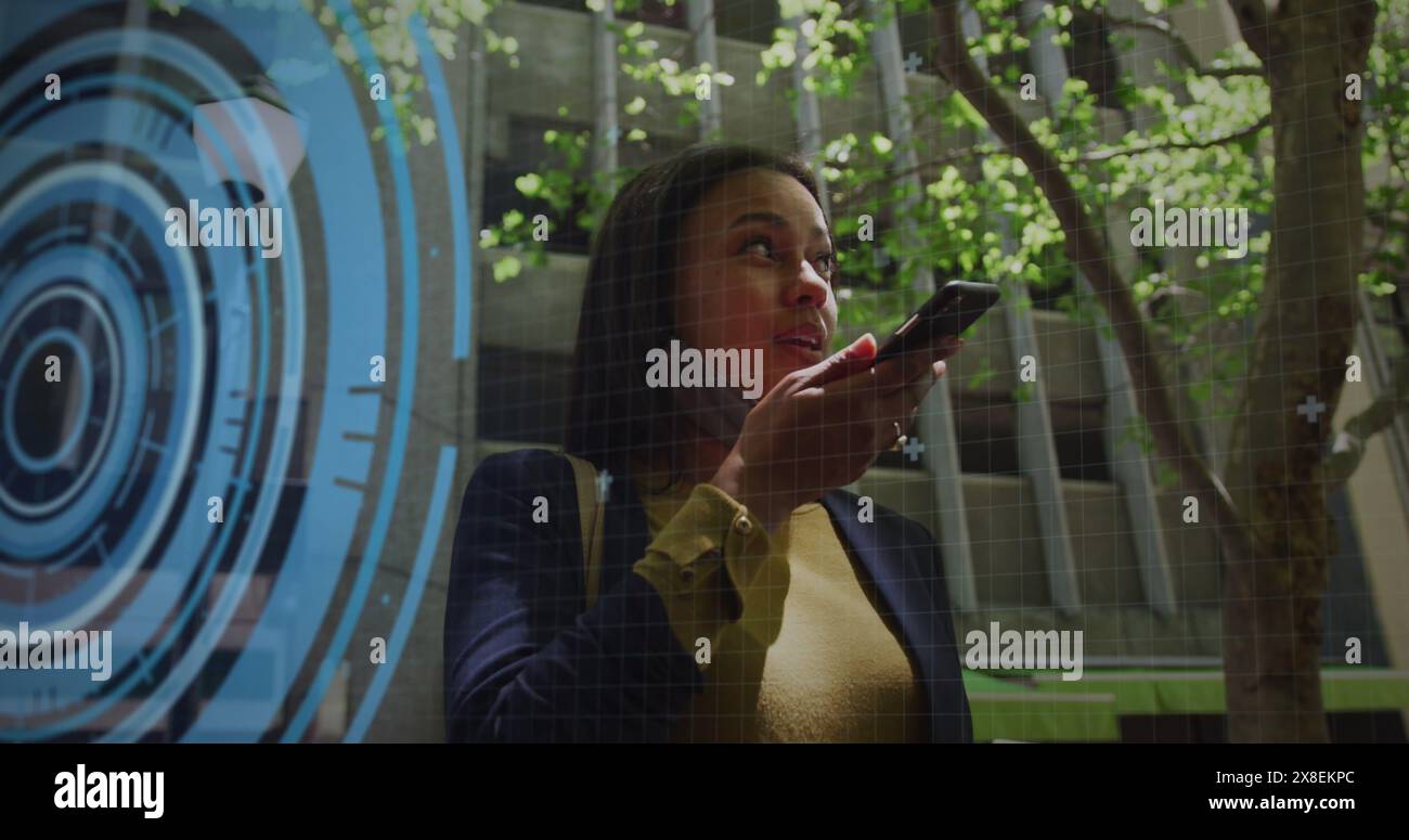 Image of loading circles, biracial woman talking on speaker of ...