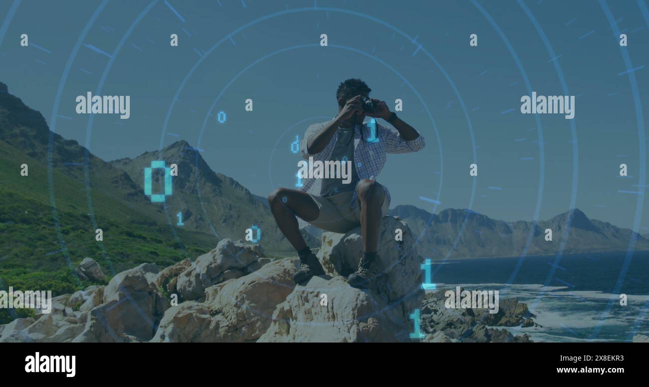 Image of binary codes, circles over african american man looking ...