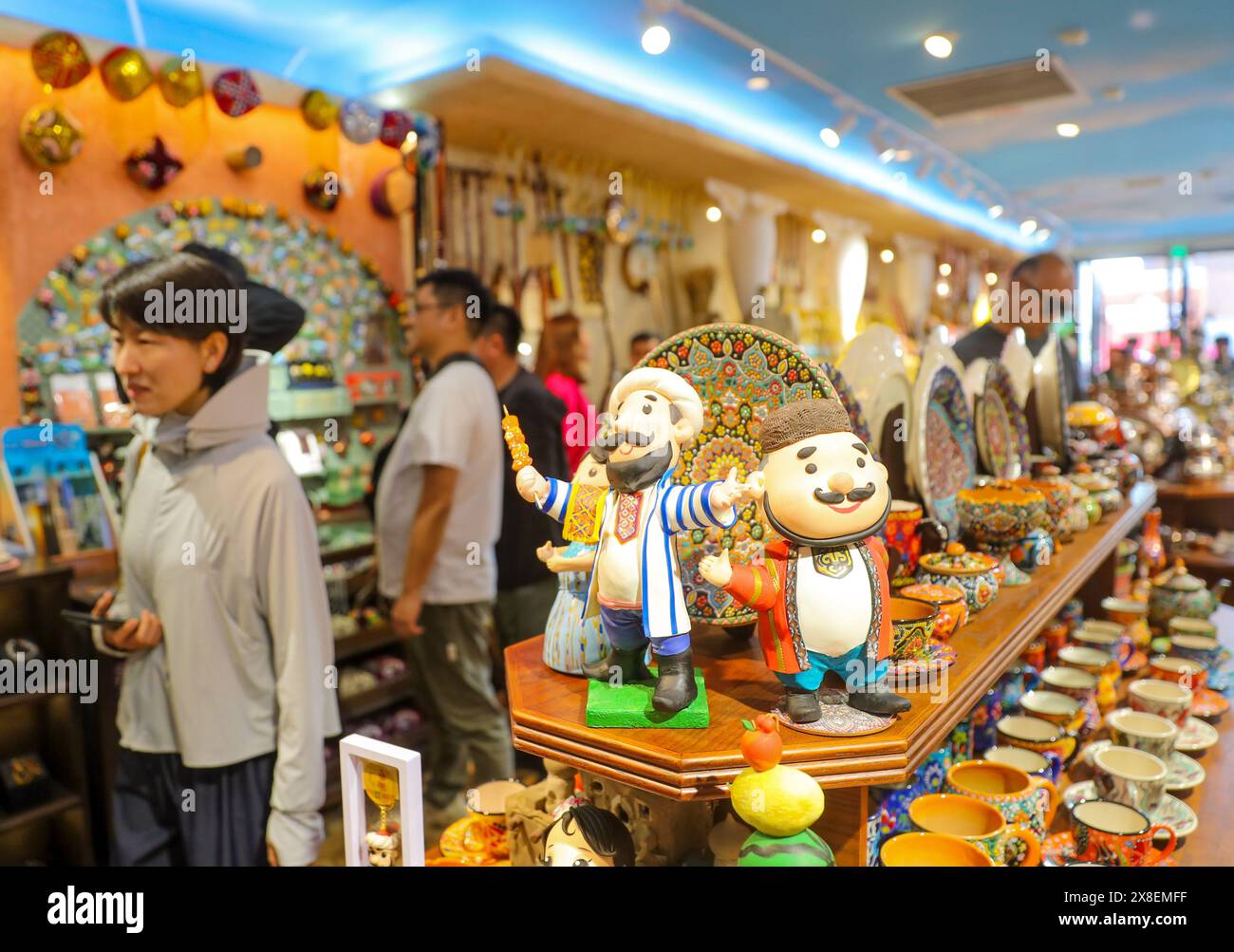 URUMQI, CHINA - MAY 24, 2024 - Tourists select goods at an arts and ...