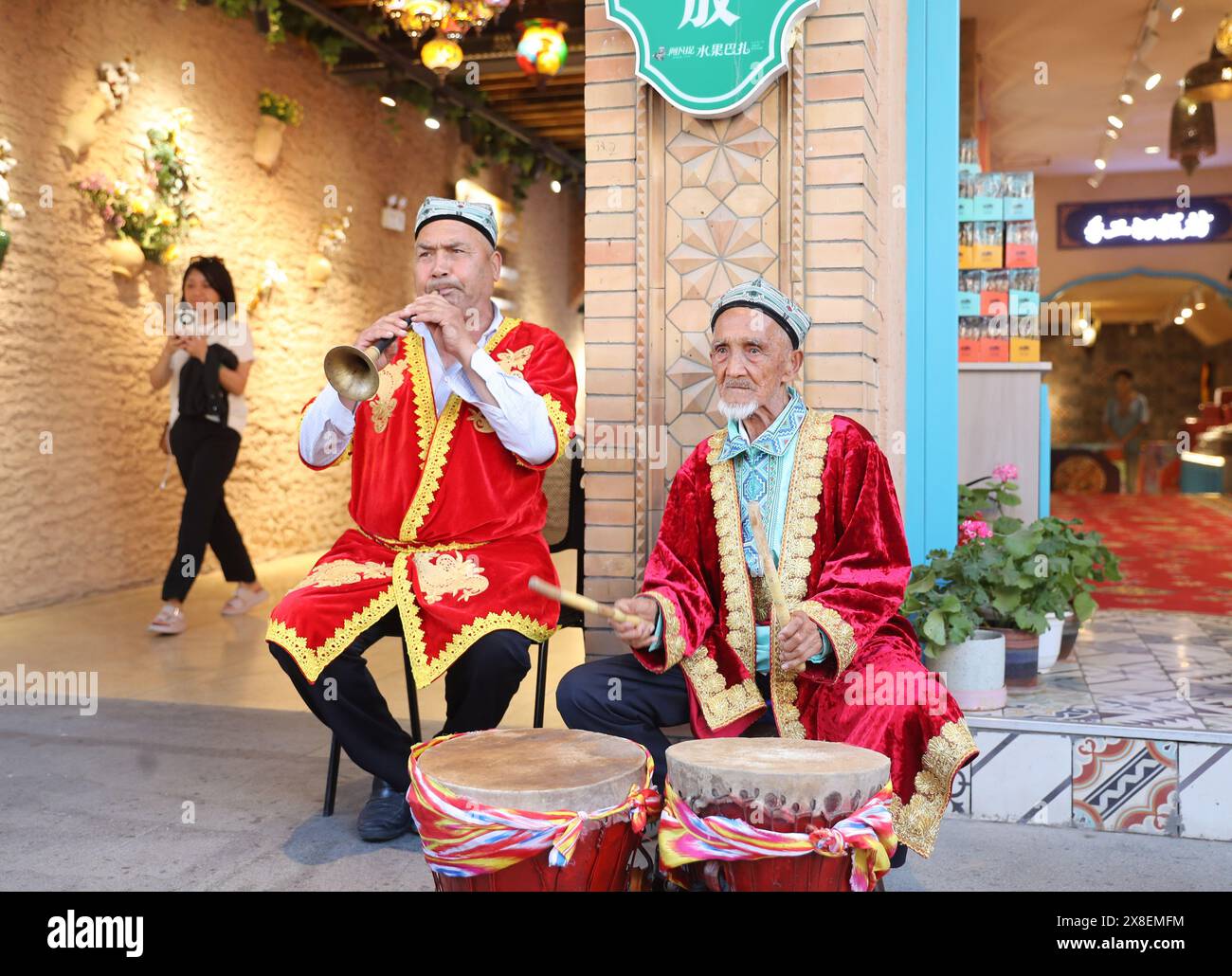 URUMQI, CHINA - MAY 24, 2024 - Two elderly people play music for ...