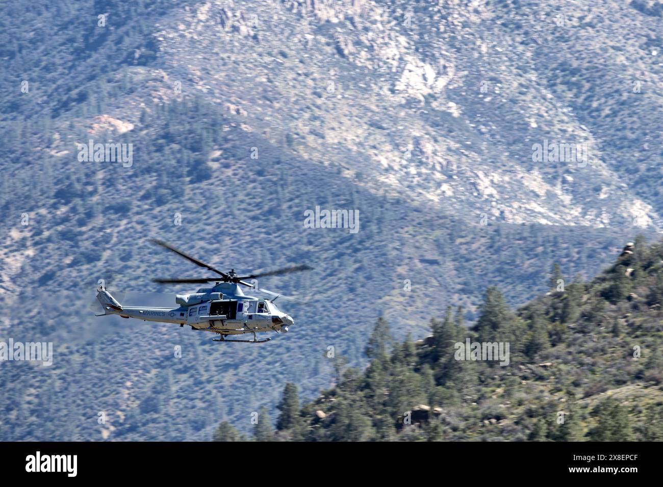 A United States Marines UH-1Y Venom helicopter flies through the ...