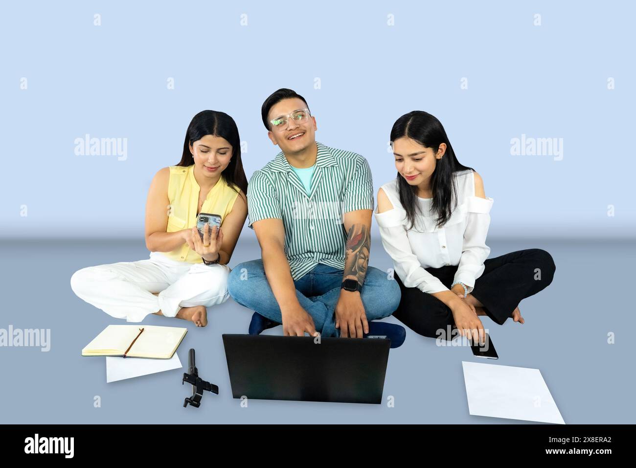 A group of copywriter friends with notepad, mobile phone, laptop giving ...