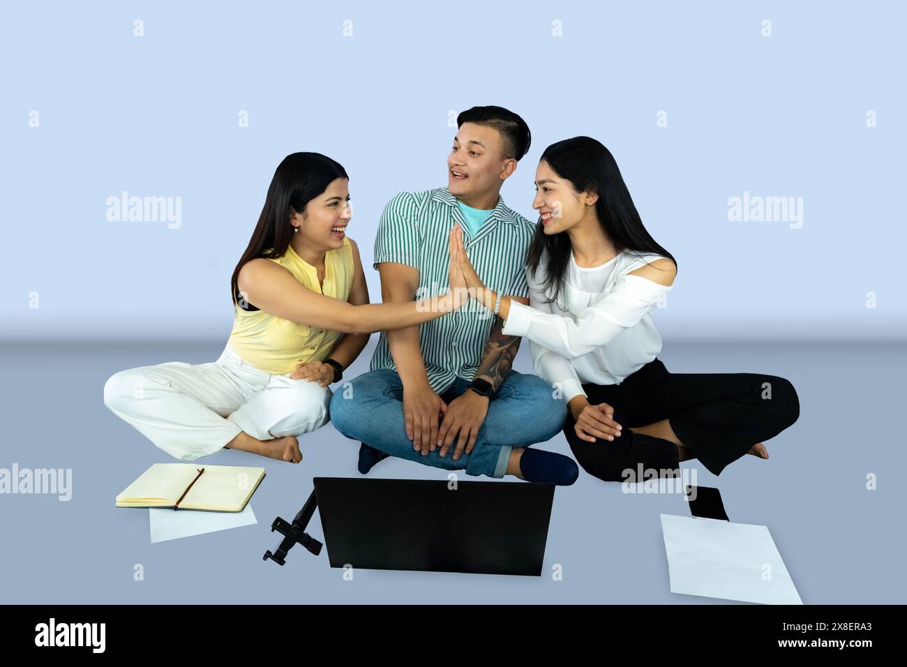 A group of copywriter friends with notepad, mobile phone, laptop giving ...