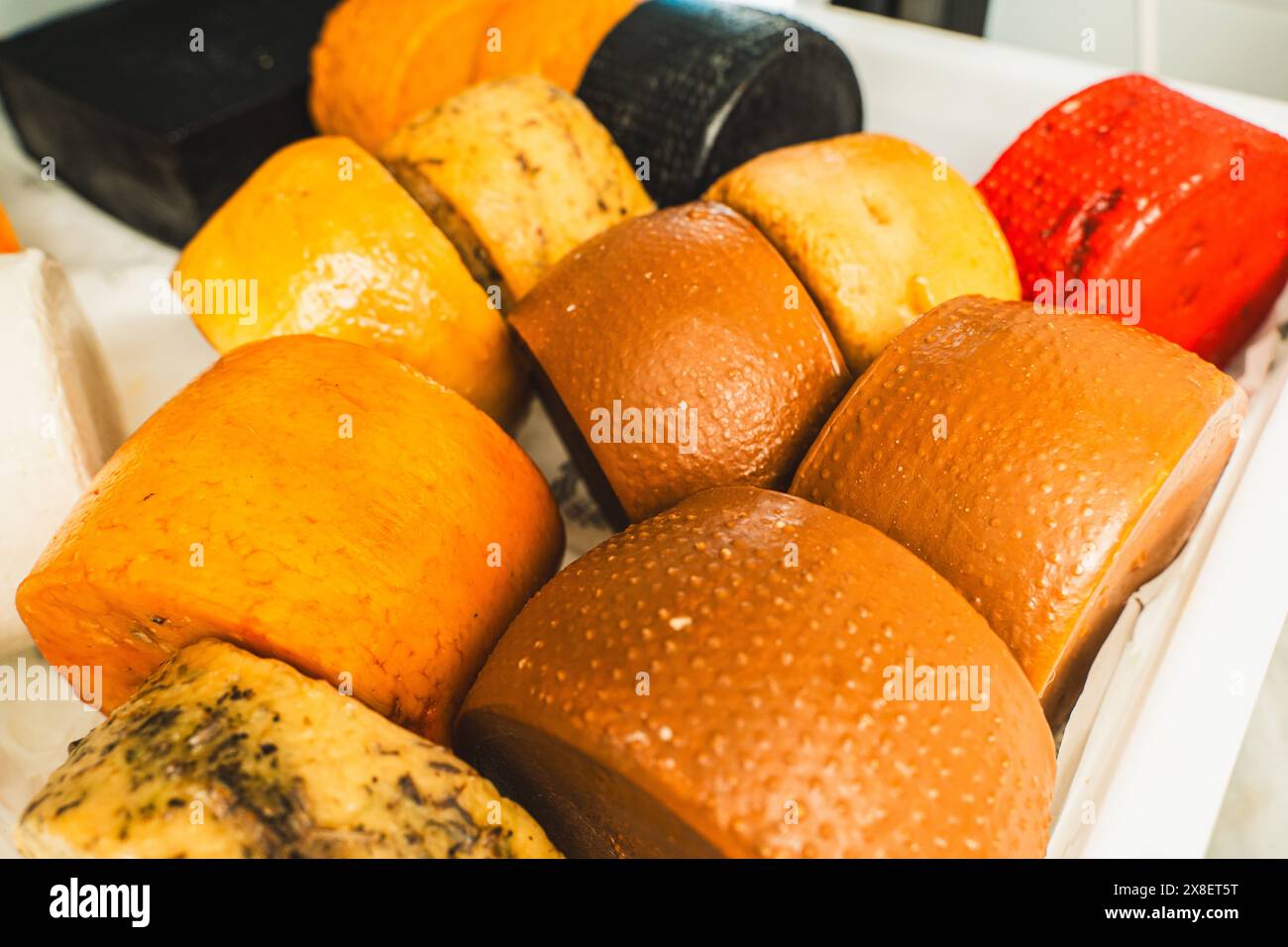 Cheese of different varieties and colors. A lot of cheese pieces, heads ...